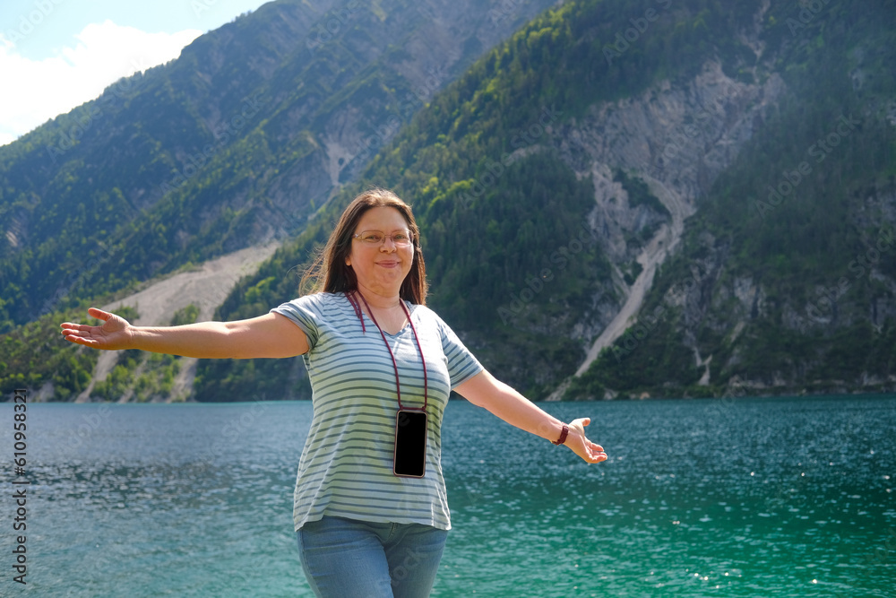 mature women of 50 years old smiles against backdrop of lake Achensee ...