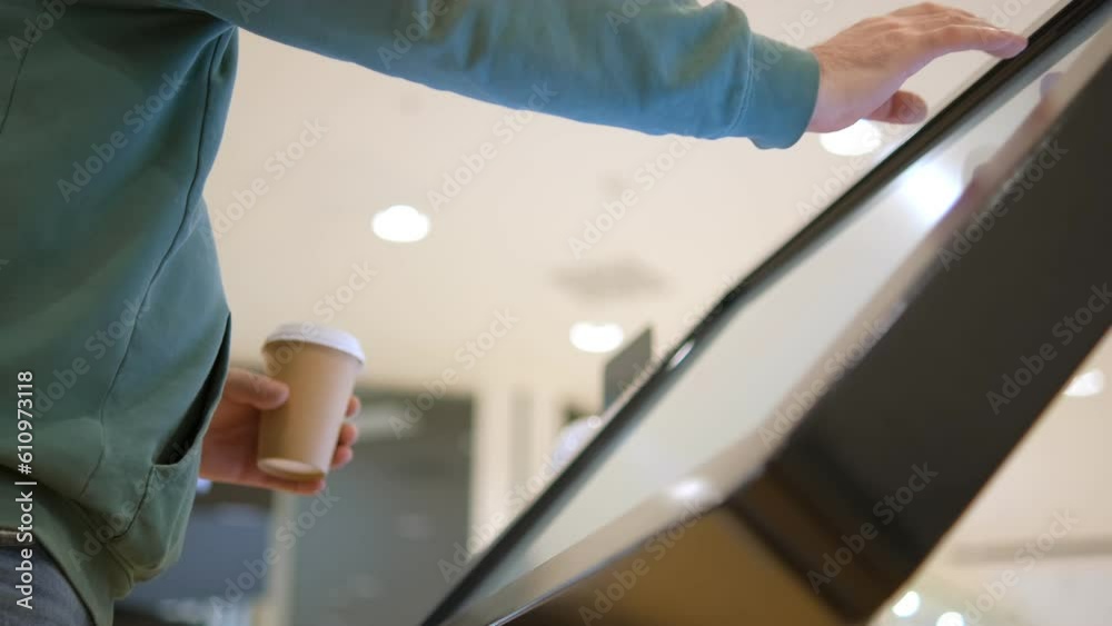 Man using touchscreen terminal in mall. Detail view outstretched male ...