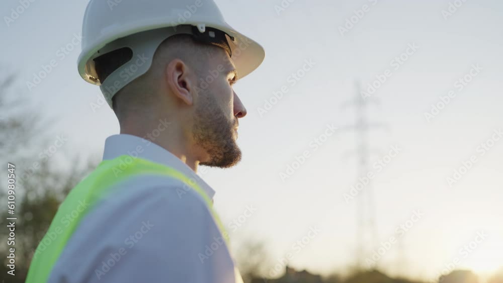 Side View of Handsome Engineer Putting on his Safety Gear Helmet at Job ...