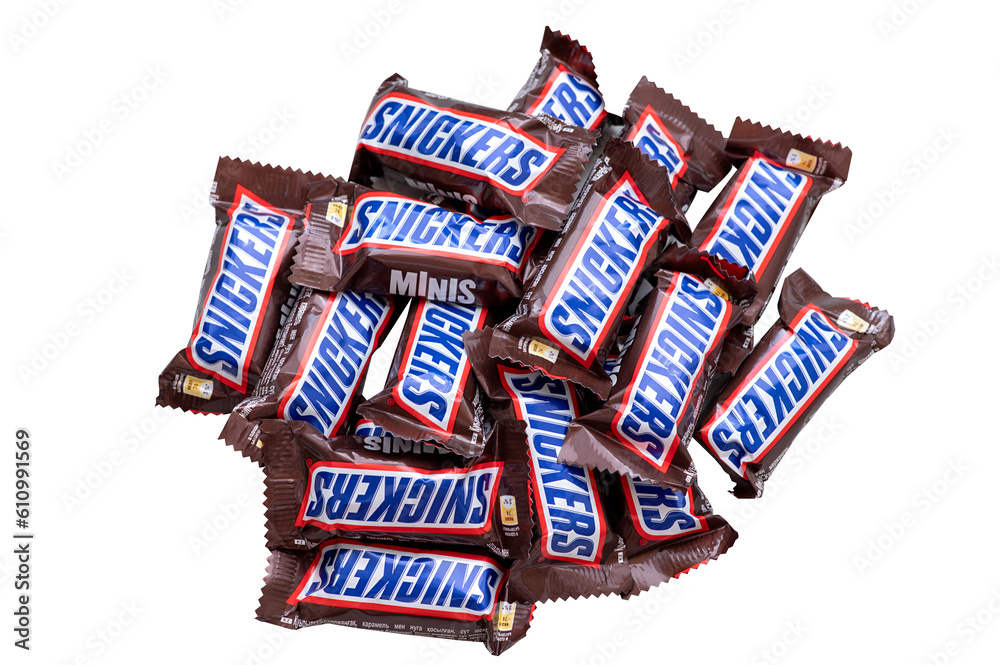 A heap of Snickers mini chocolate bars on PNG transparent background. Confection with the ...