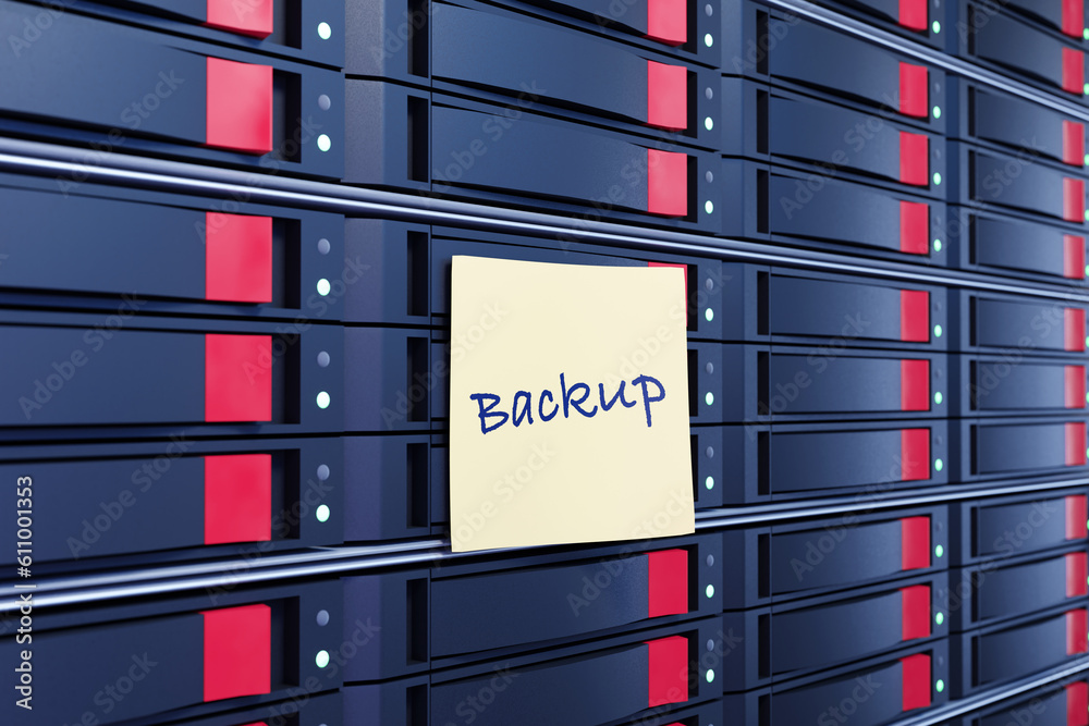Yellow sticky note written with the word Backup stuck on stacks of server NAS devices ...