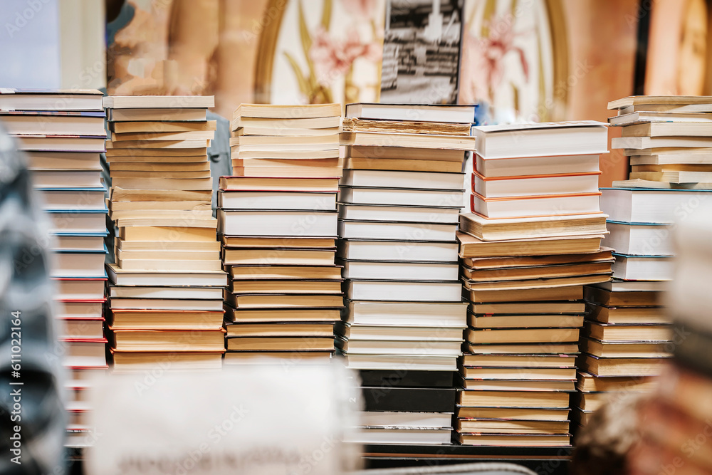 Books stacked on desk in bookstore, abstract education background Stock ...