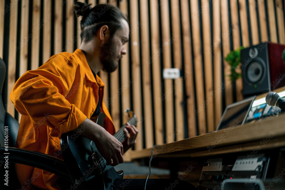 rock performer with electric guitar in recording studio recording ...