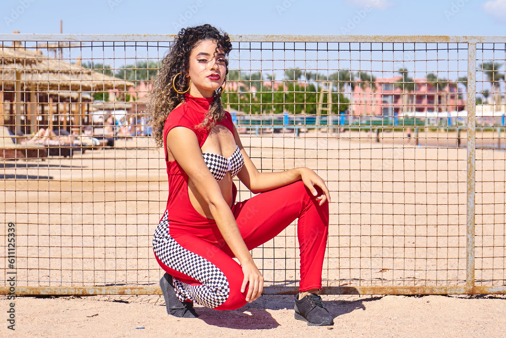 Sexy woman with slim figure in red suit and curly hair.Attractive ...