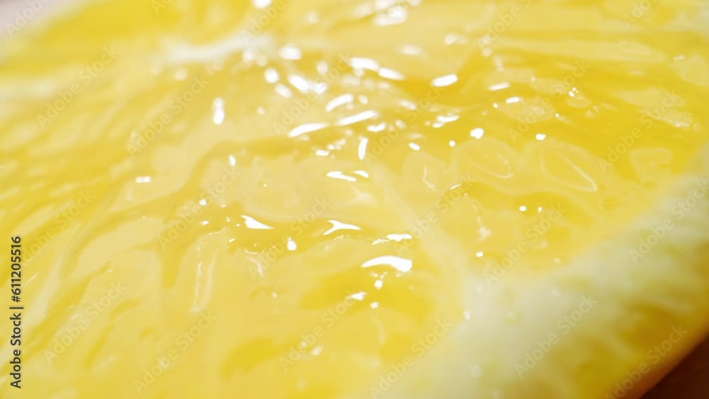 In a macro video, the lemon's textured peel becomes a landscape of ...