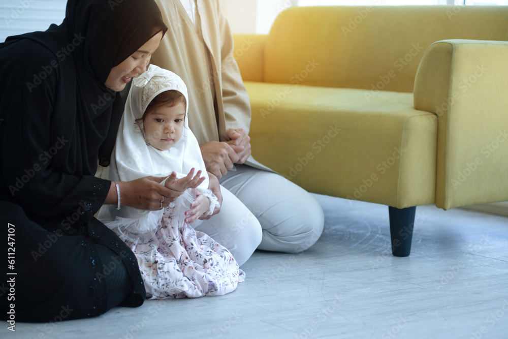 Muslim mother in traditional dress teaching her daughter Dua gesture ...