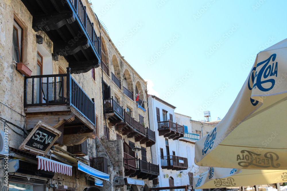 KYRENIA . CYPRUS. Old stone houses with arched Windows and balconies on ...