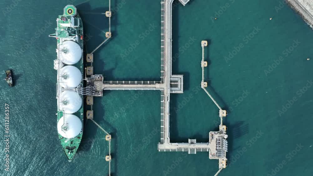 LNG (Liquified Natural Gas) tanker anchored in Gas terminal gas tanks ...