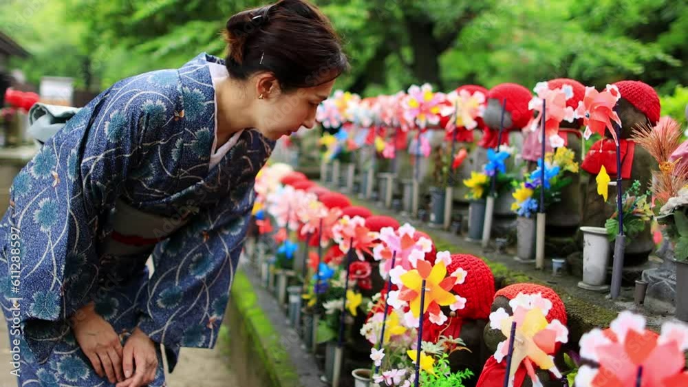 beautiful Japanese woman in a kimono admiring traditional shrine in ...