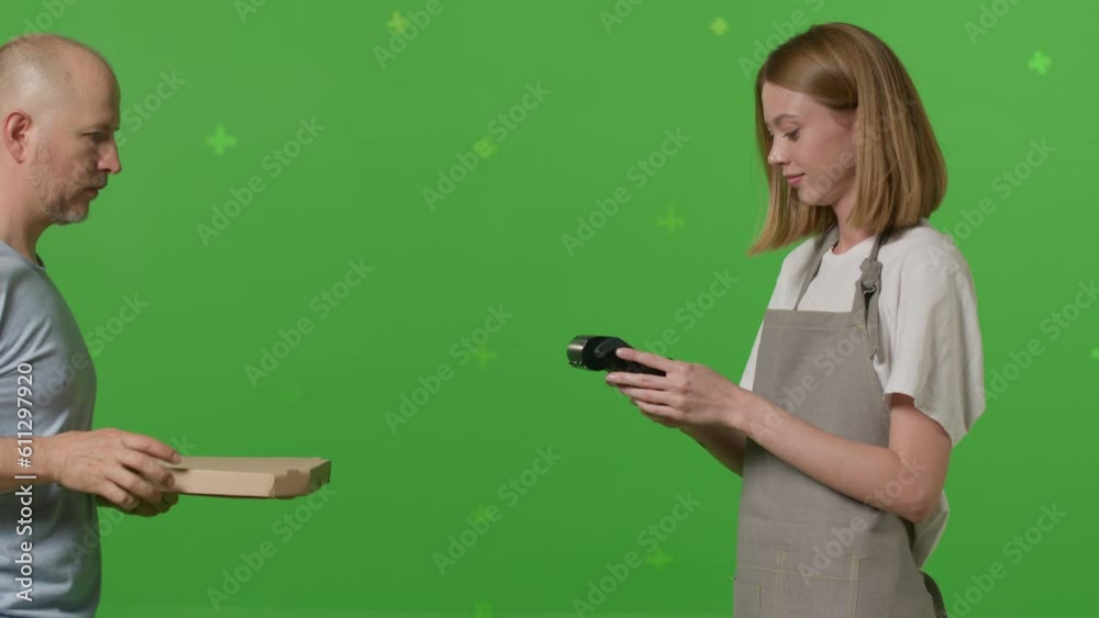 Girl waiter passing a box of pizza on green screen chroma key ...