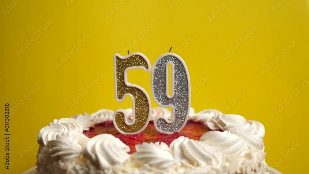 They blow out a candle in the form of the number 59, which is stuck ...