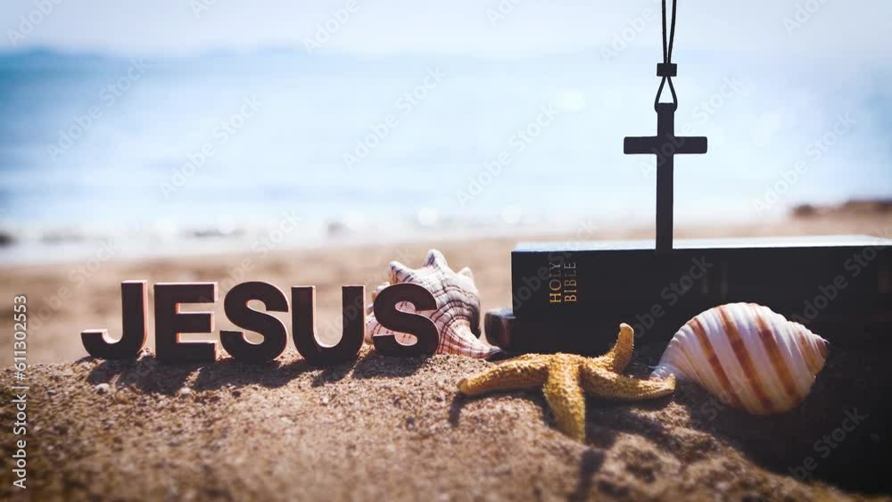 Bible book and cross of Jesus Christ on sea sand beach and church ...