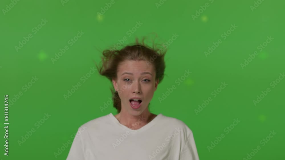 Caucasian girl in front of TV screen getting blown away. Cinema concept with chroma key. Stock ...