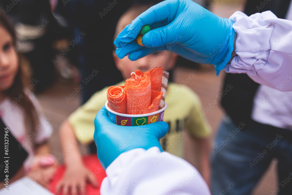 Rolled thai ice cream preparation, process of cooking coloured fried ...