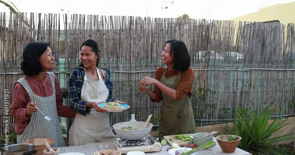 Mother and daughters cooking together traditional thai rice plate at ...