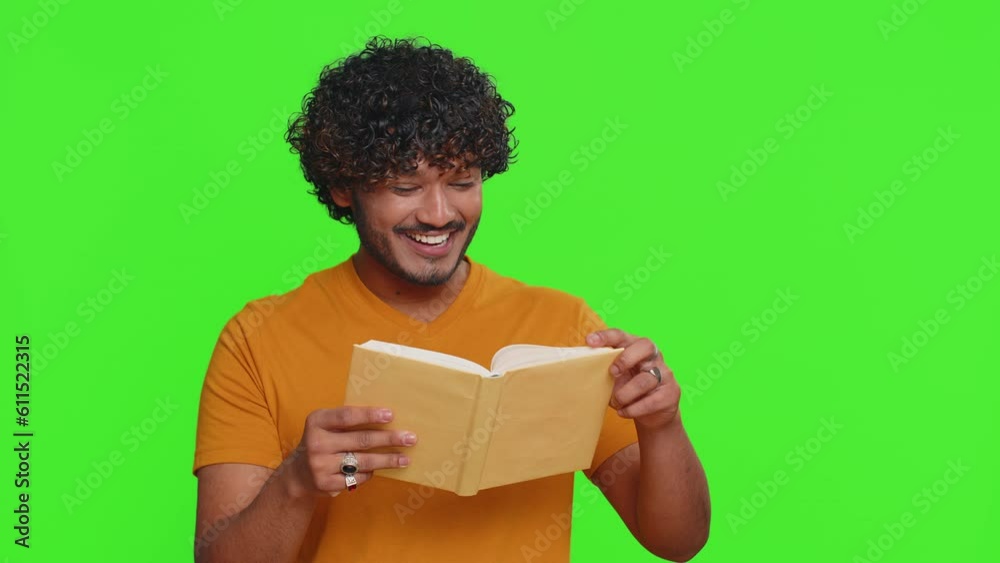 Happy indian man reading funny interesting fairytale story book ...
