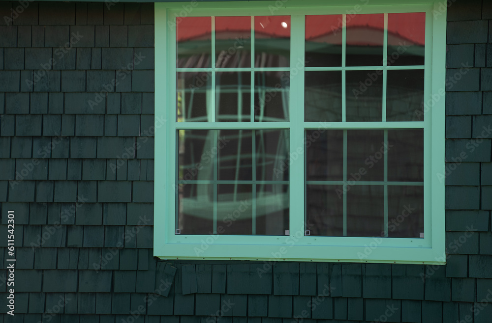 reflection in window of other windows with distortion from glass square ...