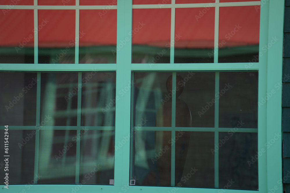 reflection in window of other windows with distortion from glass square ...