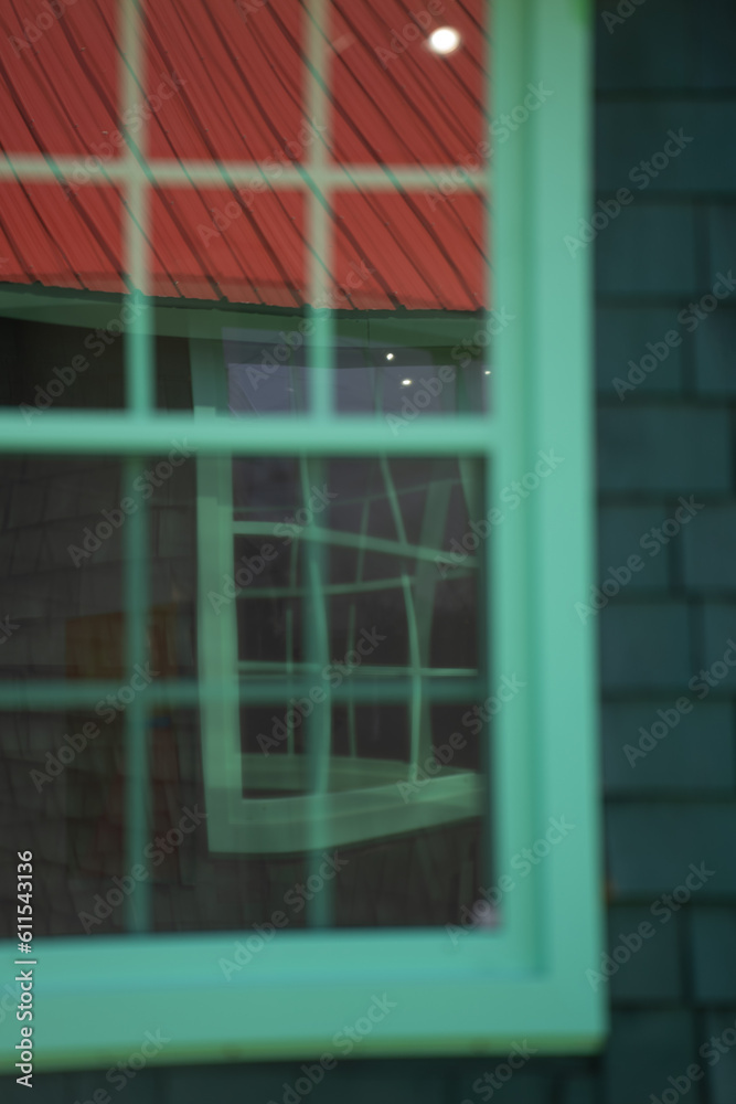 reflection in window of other windows with distortion from glass square ...