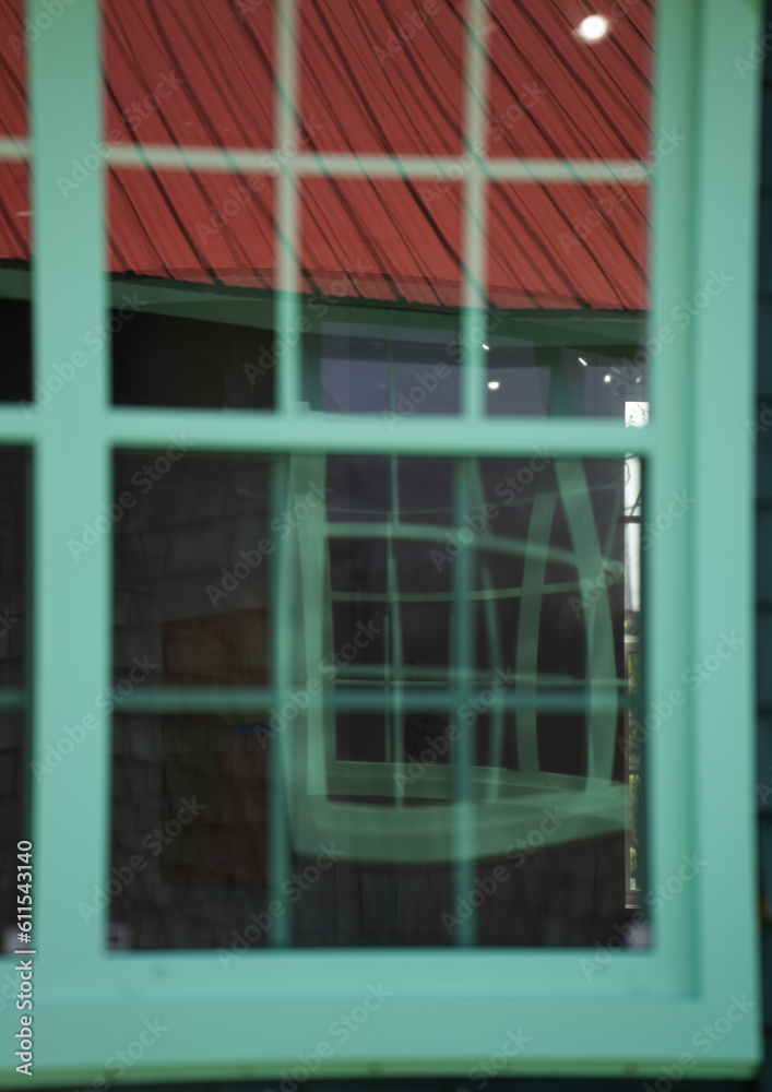 reflection in window of other windows with distortion from glass square ...