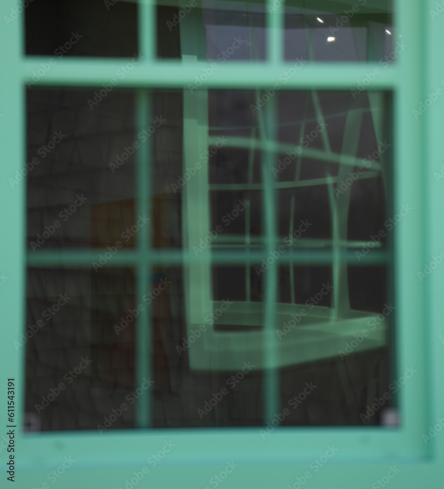 reflection in window of other windows with distortion from glass square ...