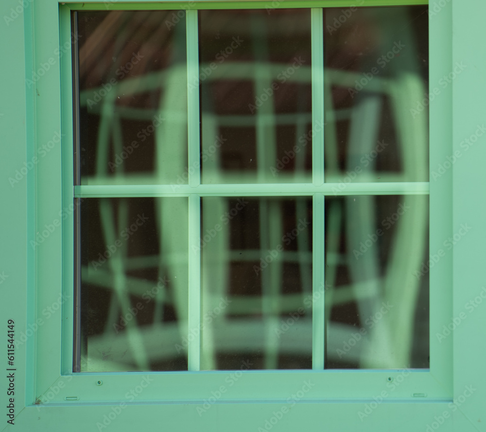 reflection in window of other windows with distortion from glass square ...