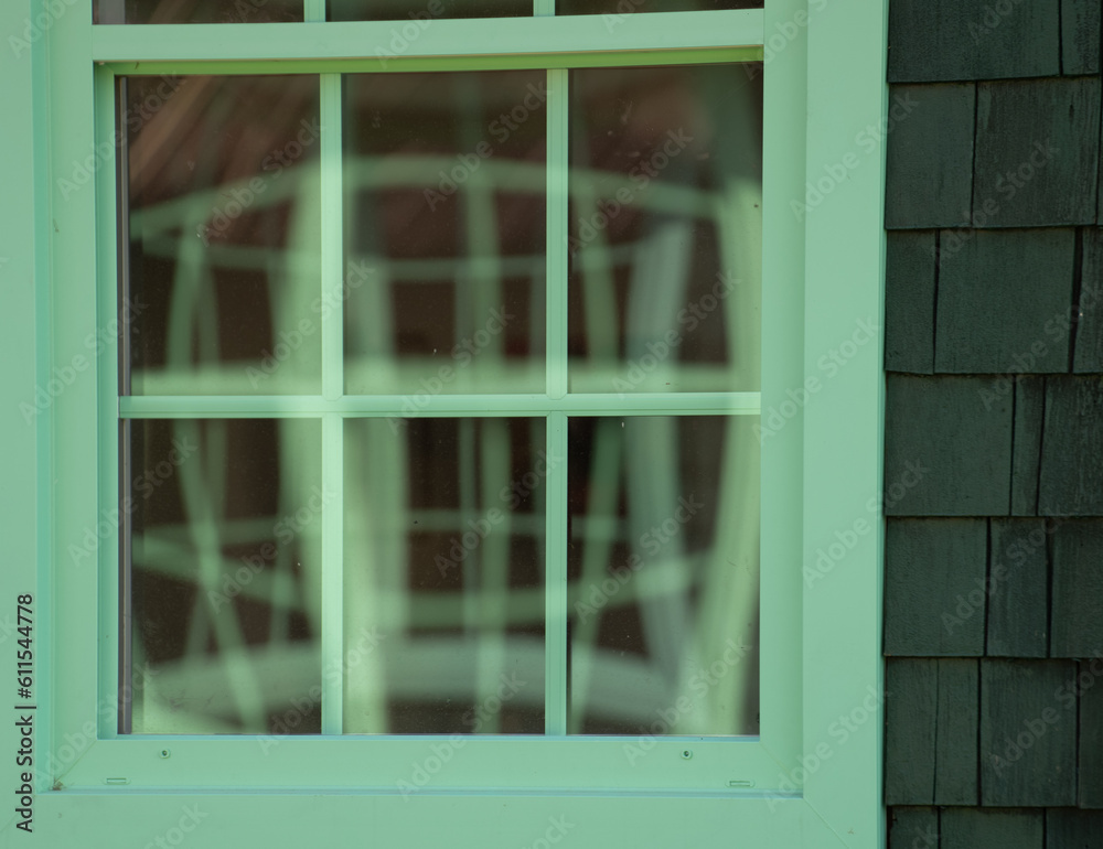 reflection in window of other windows with distortion from glass square ...