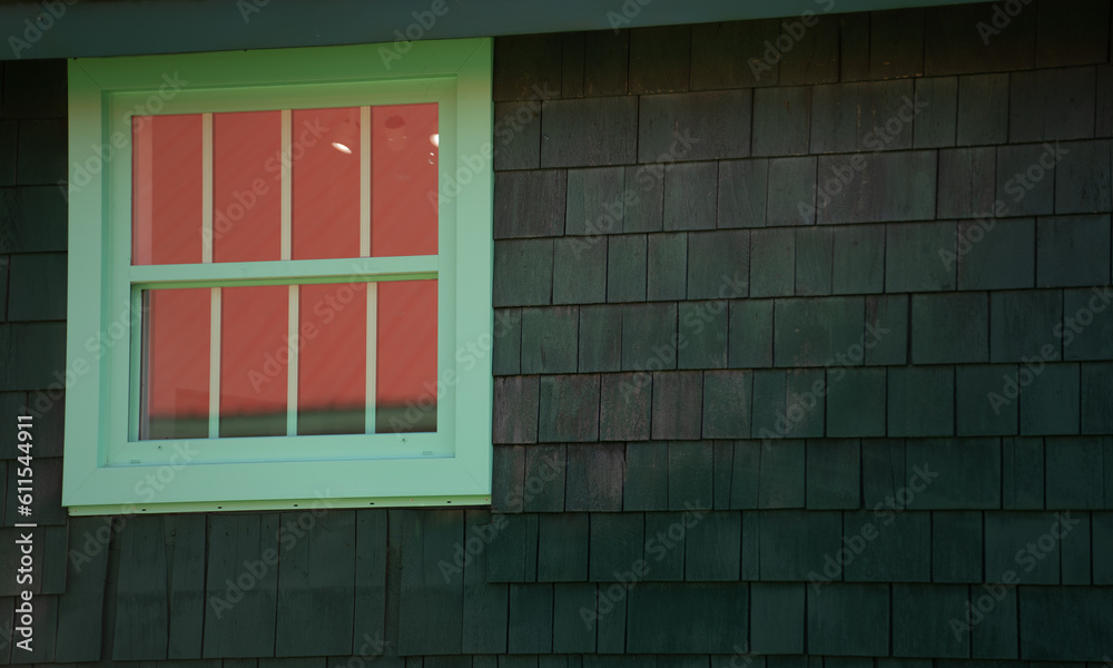 antique green wooden window frame on black shingled wall off set window ...
