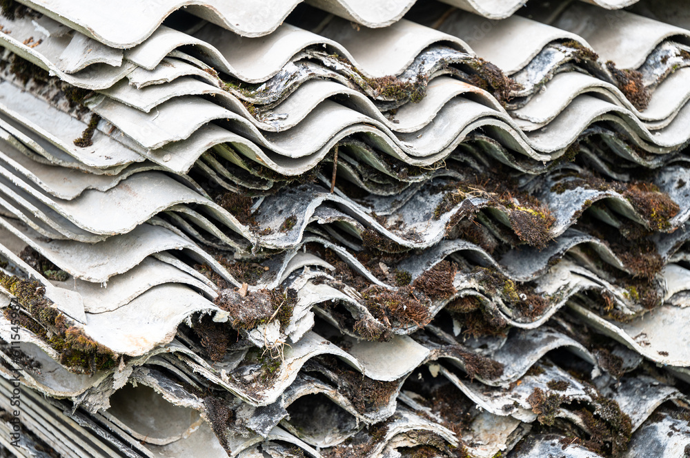 A pile of asbestos removed from an old roof. Hazardous waste prepared ...
