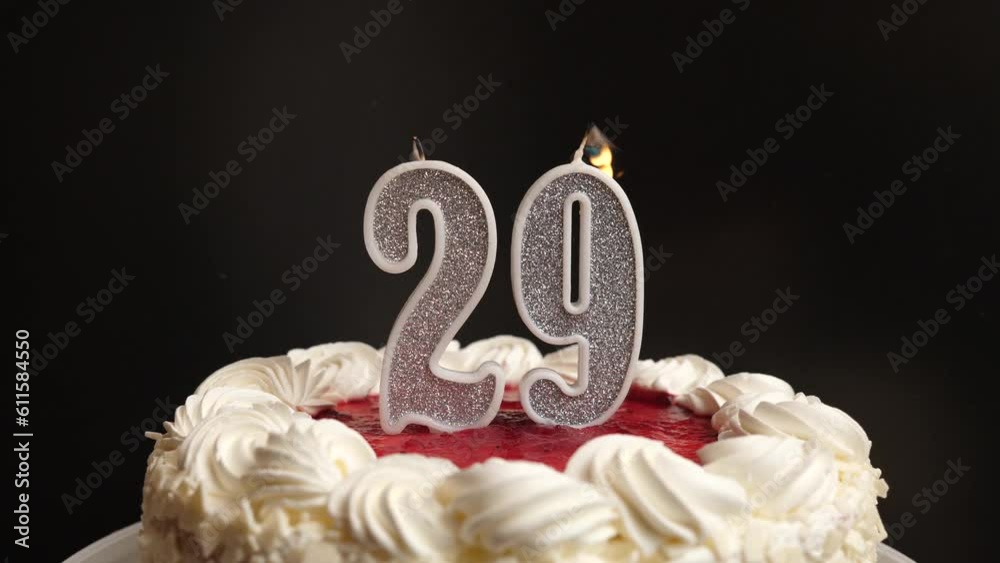 A candle in the form of the number 29, inserted into the holiday cake ...