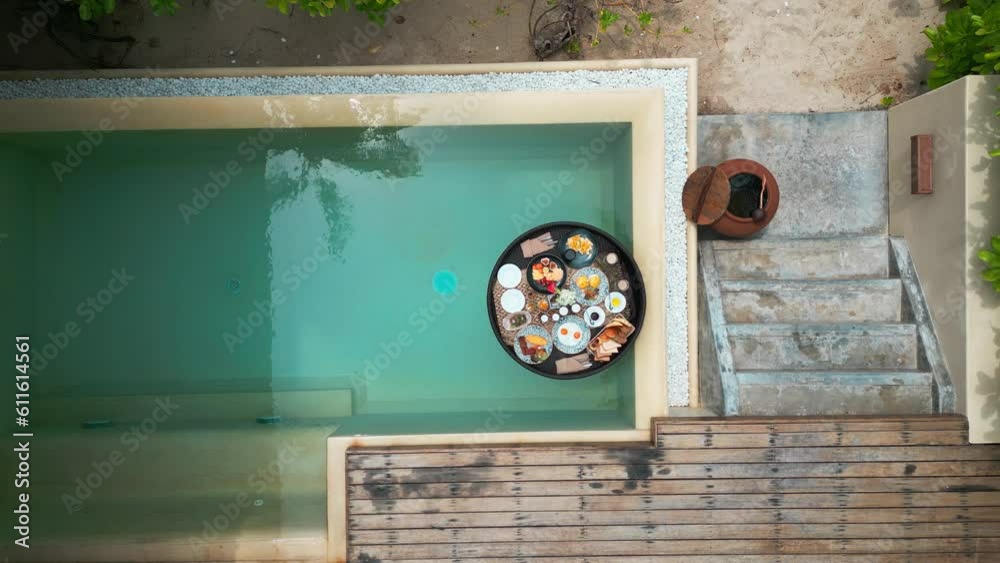 Vidéo Stock Aerial view of Luxurious floating breakfast in private pool ...