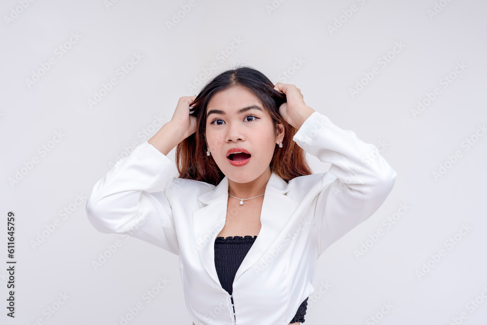 A distressed young woman with raised eyebrows and mouth wide open while ...