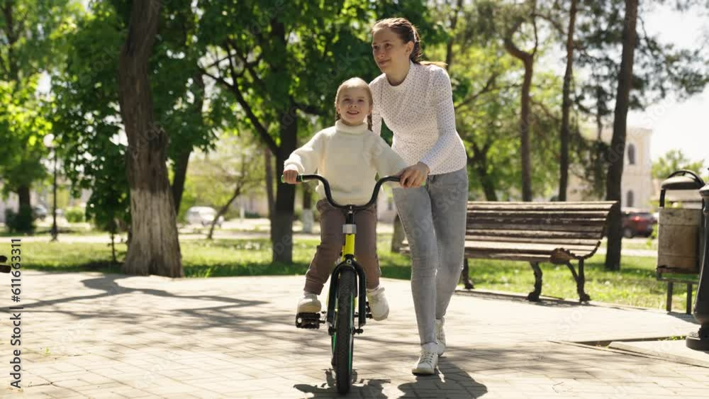 child learn ride bike. mother daughter girl park. happiness smile ...