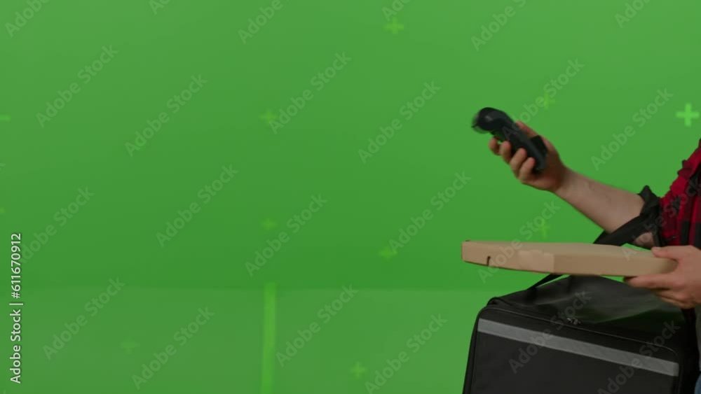 Caucasian male courier passing a box of pizza on green screen chroma ...