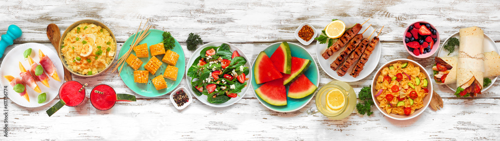 Summer food table scene over a white wood banner background. Mixture of ...