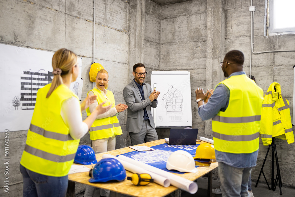 Team of structural engineers and architects giving applause for ...