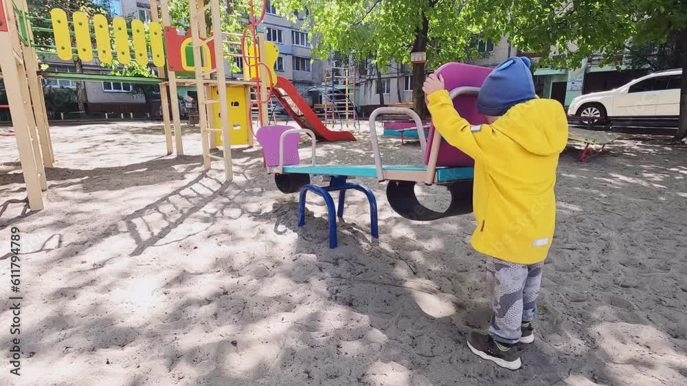 The child raises and lowers the swing and runs around the playground ...