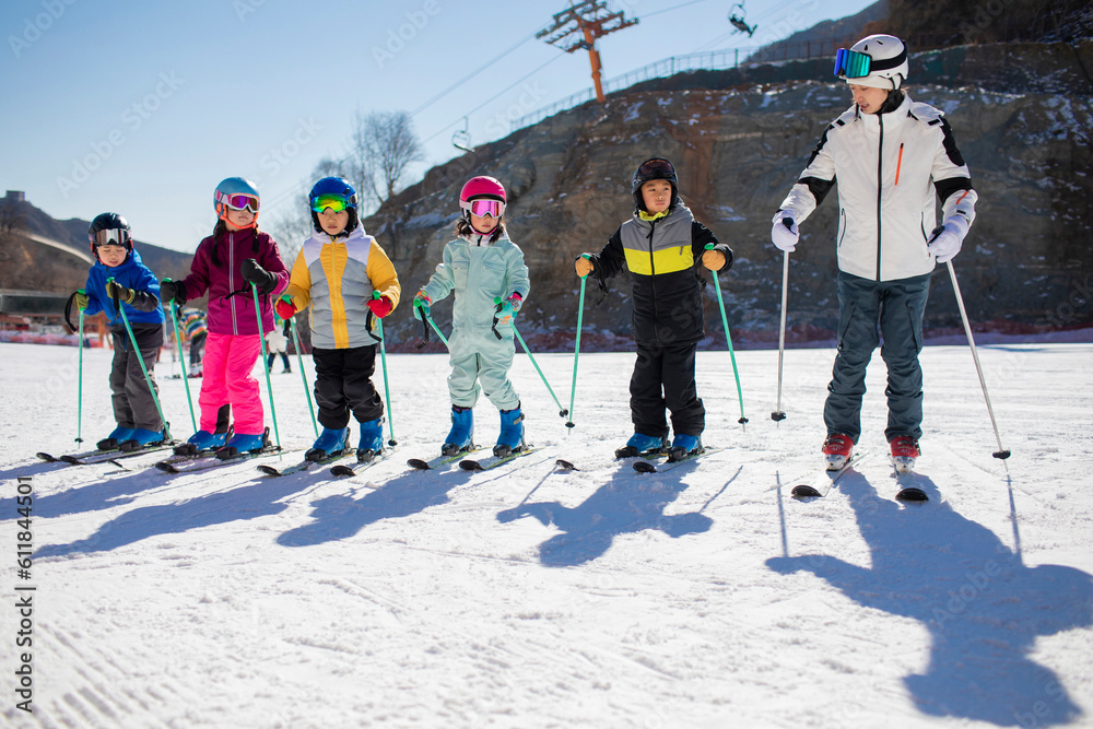 Children learning how to ski with their coach Stock Photo | Adobe Stock