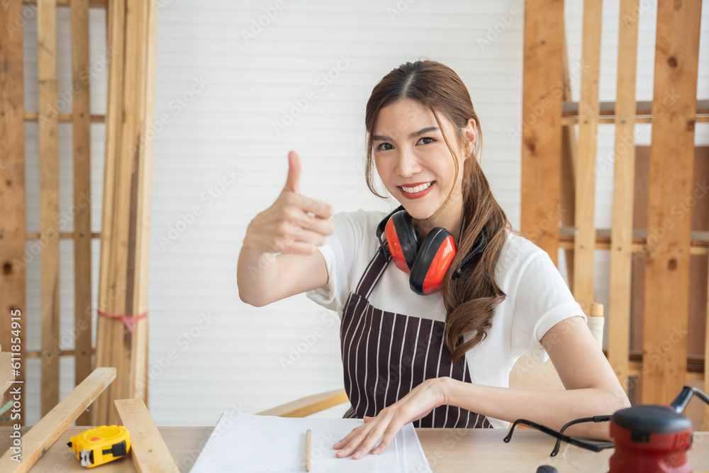 Portrait of happy asian woman thumbs up to camera with smiling. She ...