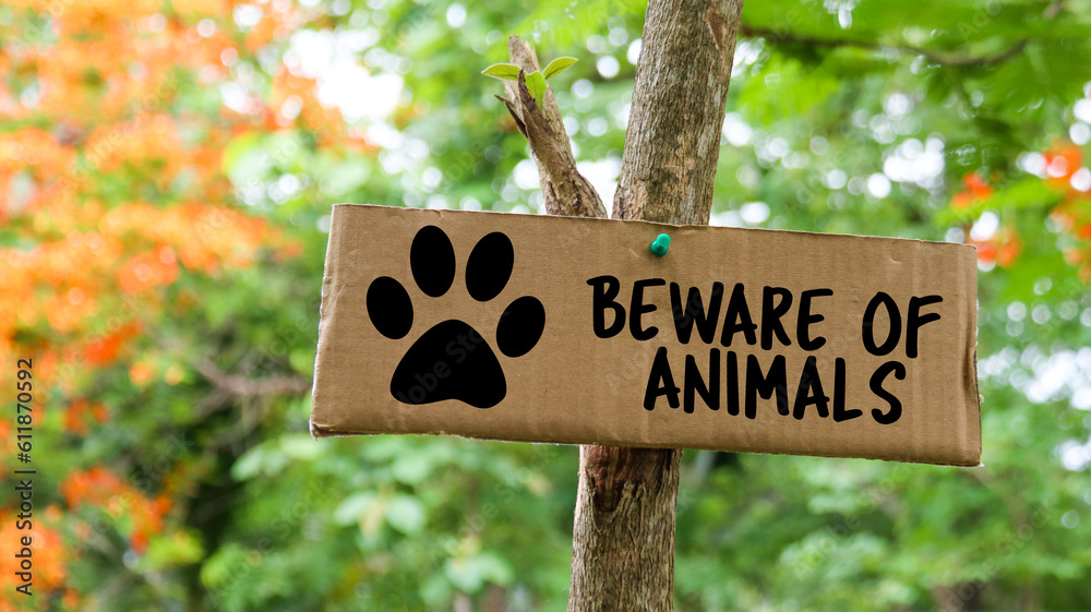 Brown paper label with drawing of dog footprint and the text beware of ...