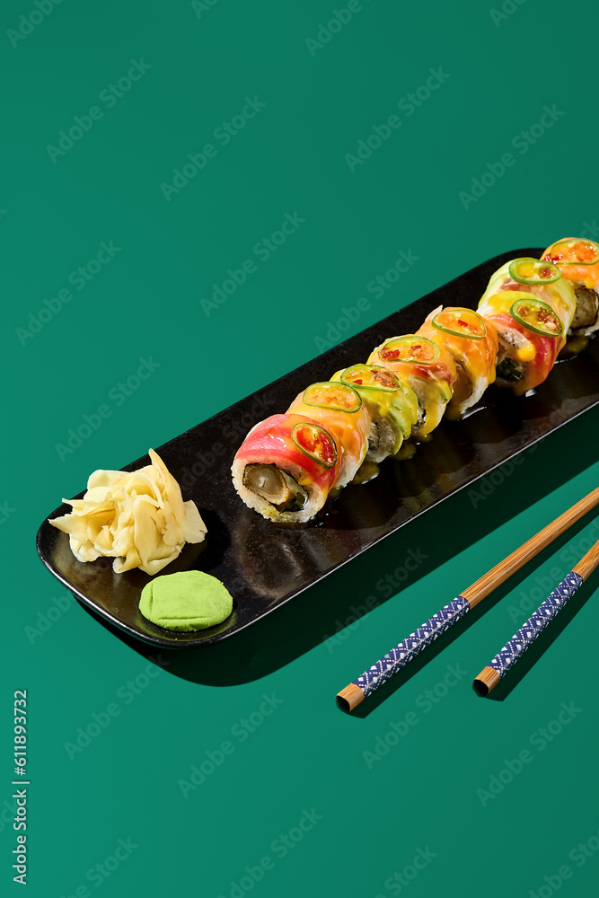 Vertical side-view image of a sushi roll with tuna, salmon, and avocado ...
