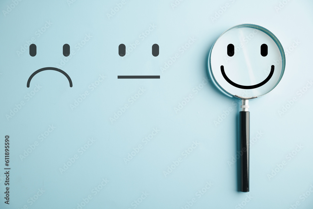 Find joy smiley face icon magnified in glass among sadness. Customer ...