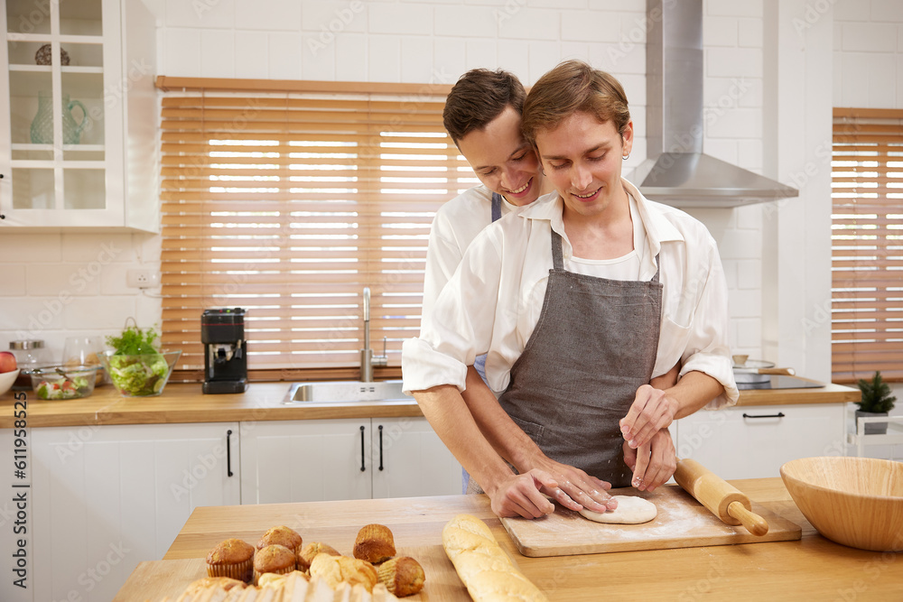 Foto de LGBT gay couple making a bread together in the kitchen do Stock ...