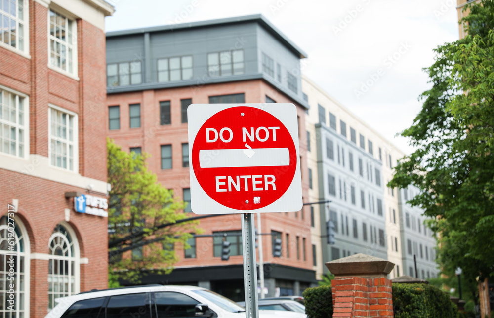 An imposing red 'Do Not Enter' sign stands tall, conveying a powerful ...