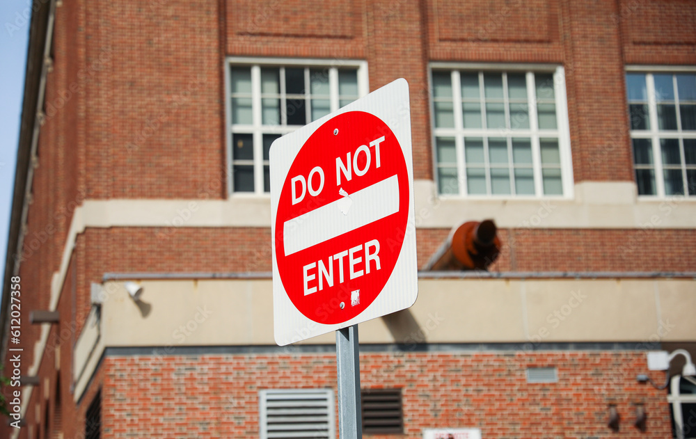An imposing red 'Do Not Enter' sign stands tall, conveying a powerful ...