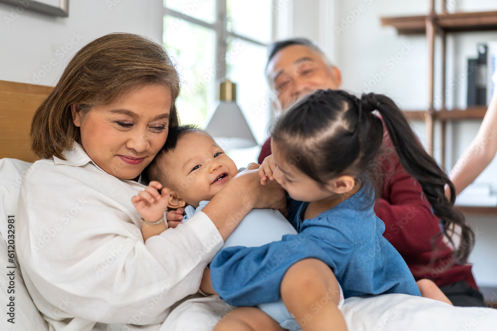 Portrait of happy love asian grandfather with grandmother playing with asian baby and little ...