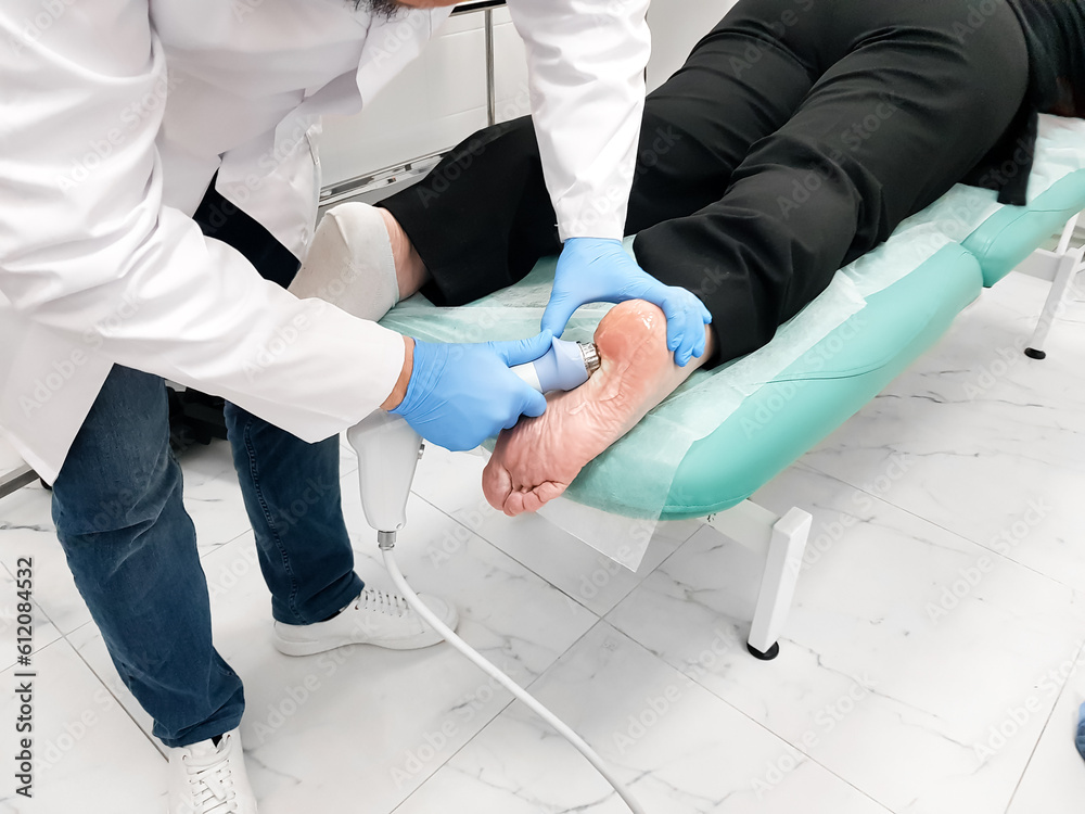 Extracorporeal shock wave therapy ESWT of heel. Visit to office of ...