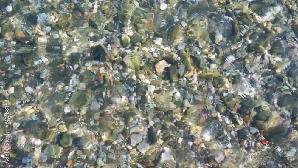 Pool water ripples and the stone pebble bottom . Waves, movement of ...