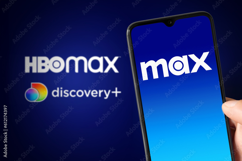Max App on smartphone with HBO Max and Discovery Plus logos on ...