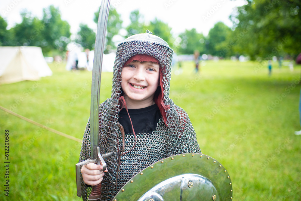 happy boy in the ring of the middle ages on a holiday, a smiling child ...